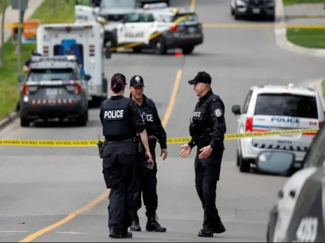 Military-clad gunman kills police officer, civilian in shooting near ...